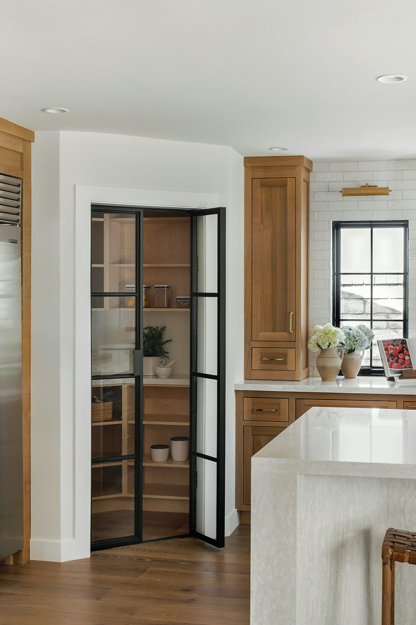 Glass Pantry Doors and Angled Waterfall Counters Spice up This Kitchen ...
